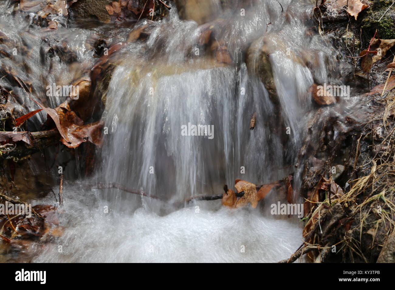 Small waterfall on a warm spring day Stock Photo - Alamy