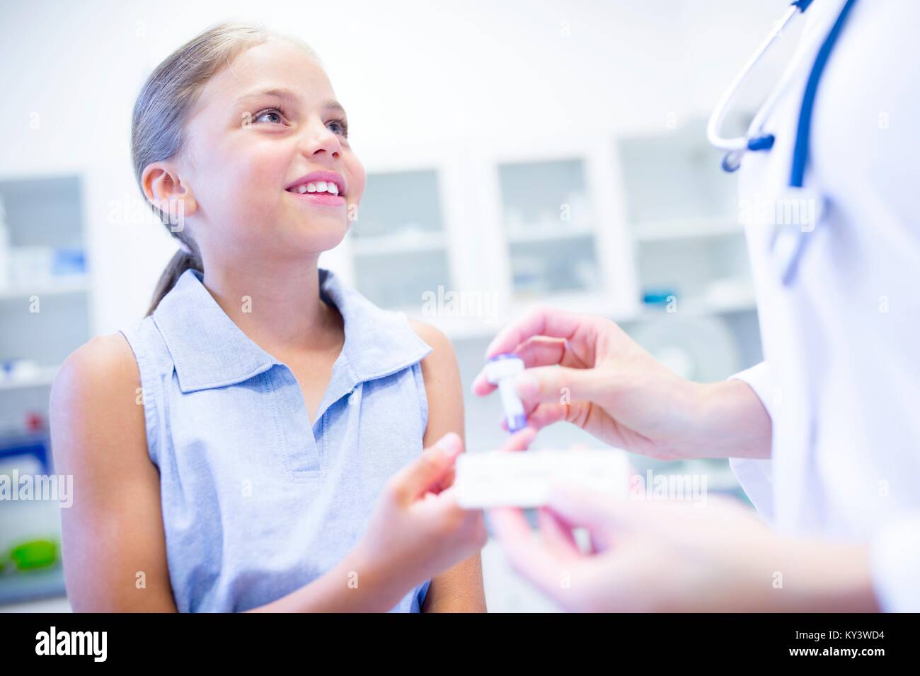 Doctor giving young girl a finger prick test Stock Photo - Alamy
