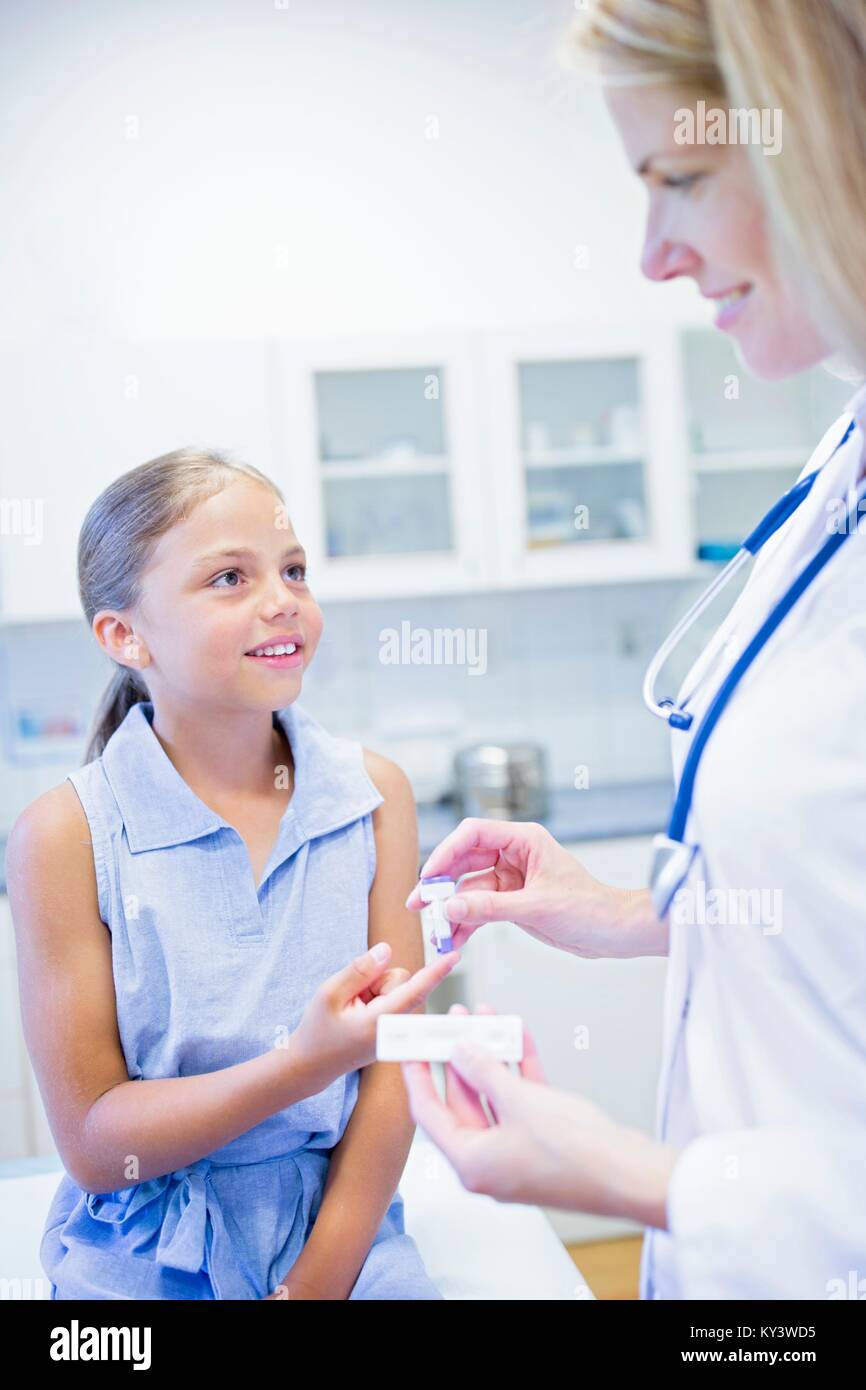 Doctor giving young girl a finger prick test Stock Photo - Alamy