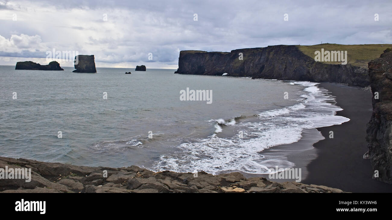 The coastal cliffs and black volcanic sandy beaches, southern Iceland ...