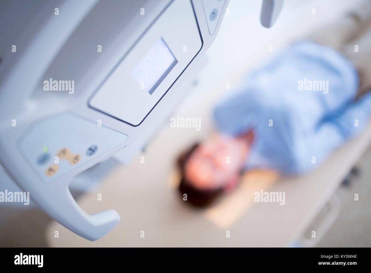 X-ray machine with female patient lying down Stock Photo - Alamy