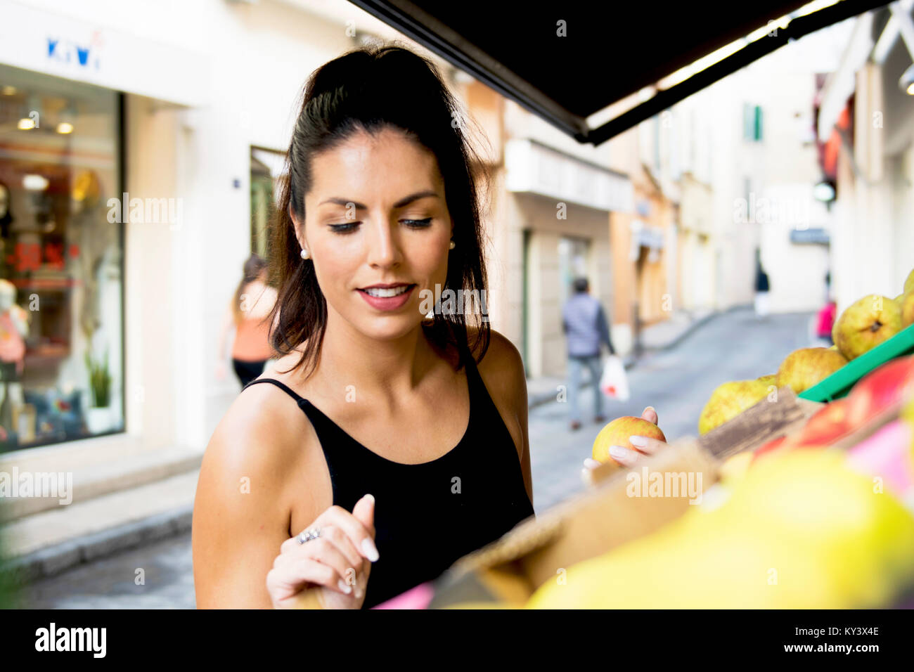 Beautiful woman shopping at an outside market Stock Photo - Alamy