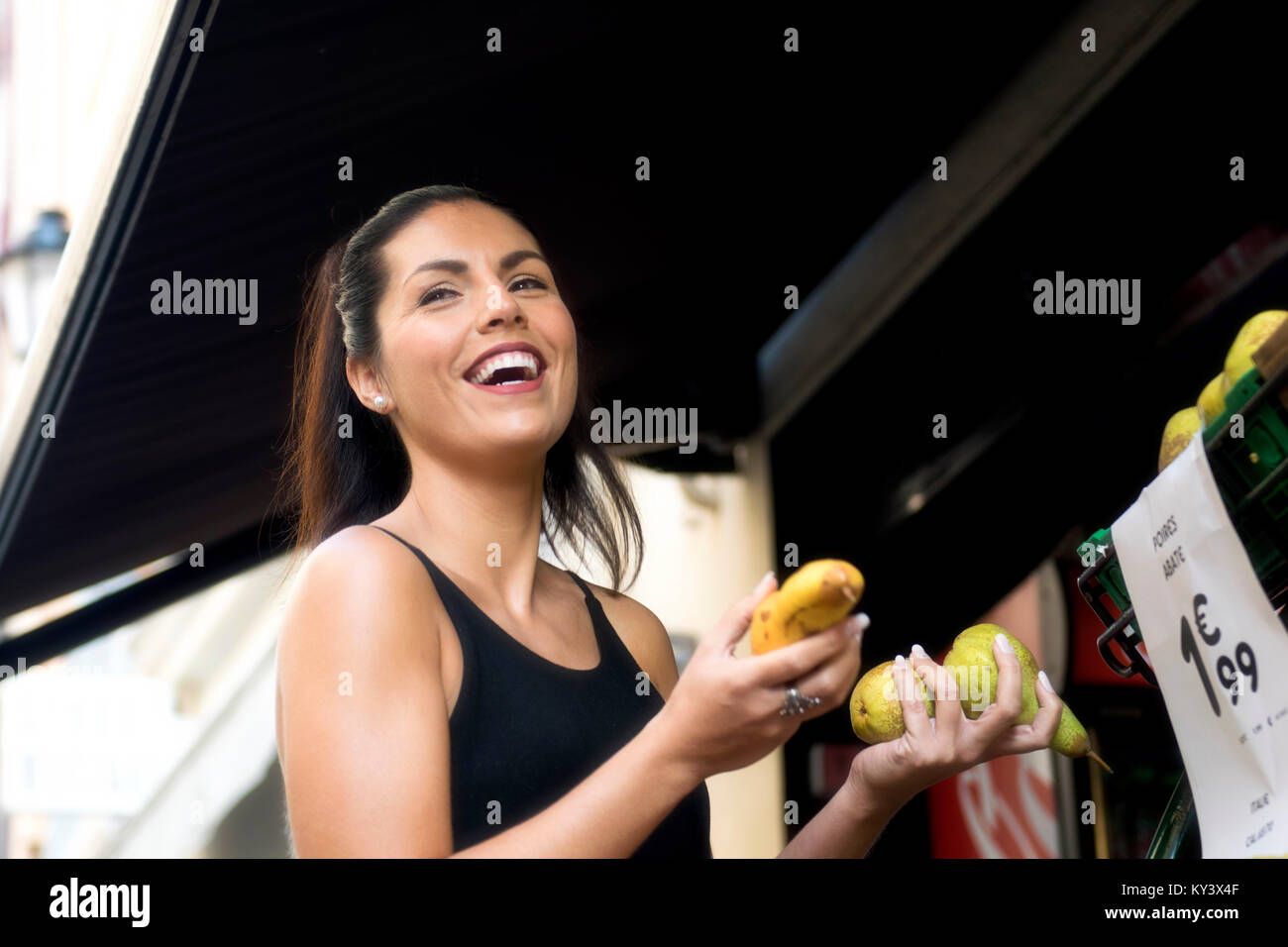 Beautiful woman shopping at an outside market Stock Photo - Alamy