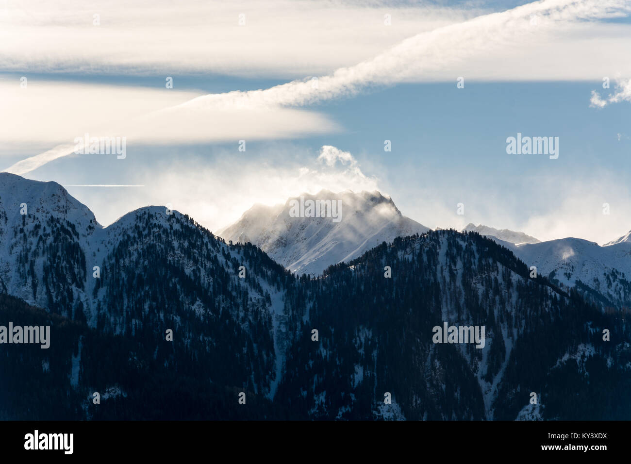 Snow blowing over the edge of a mountain in the alps in Austria Stock ...