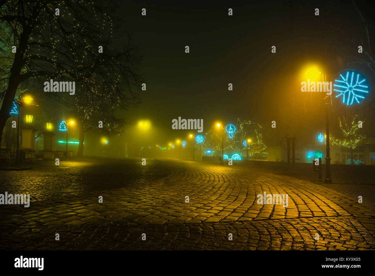 Town in the night in fog with christmas decoration Stock Photo - Alamy