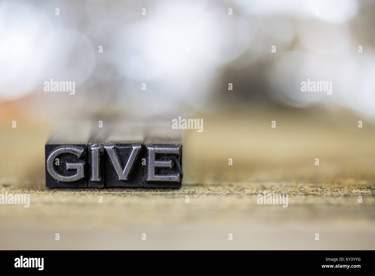 The word GIVE concept written in vintage retro metal letterpress type ...