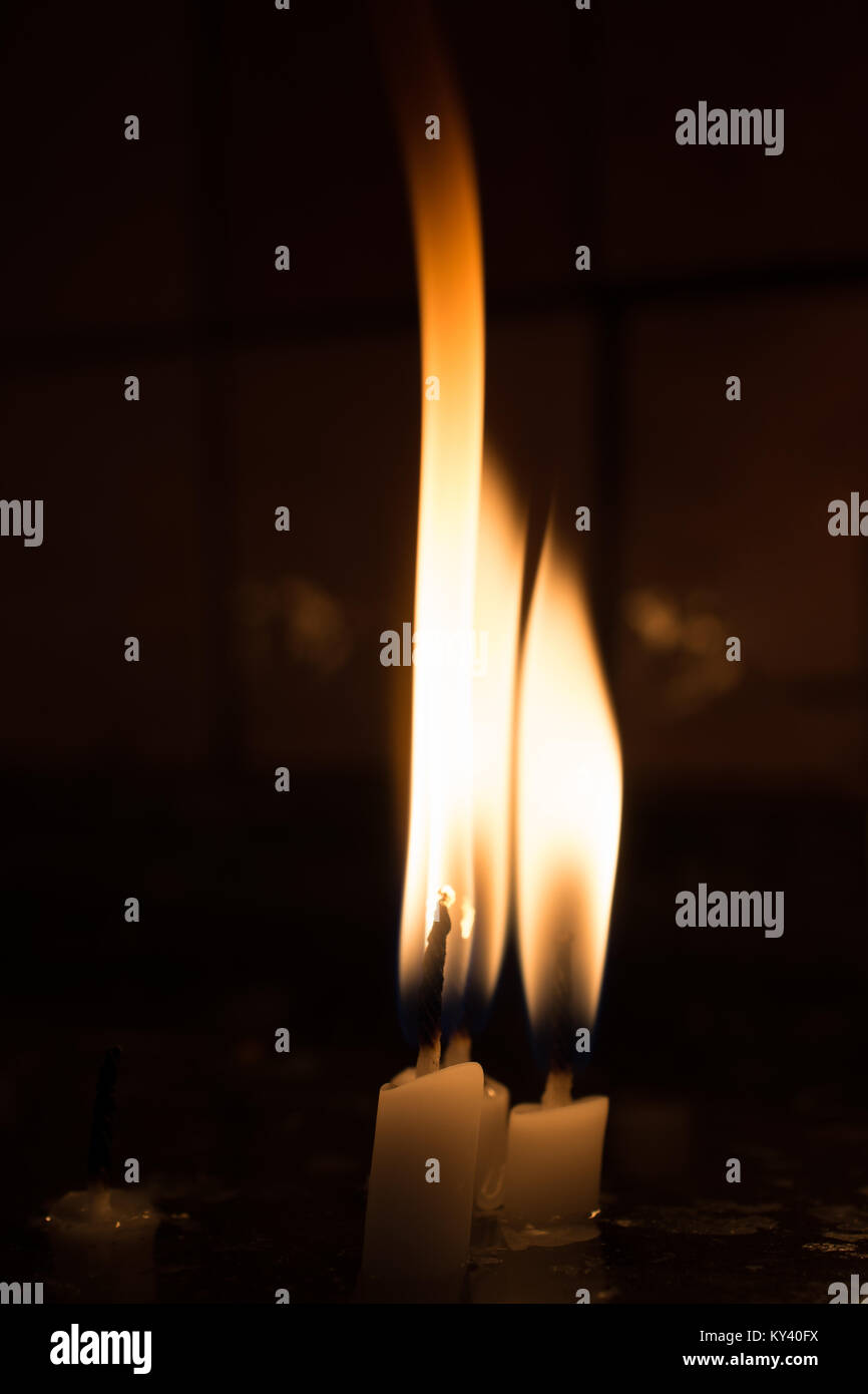 Burning candles with candle light in the dark Stock Photo - Alamy