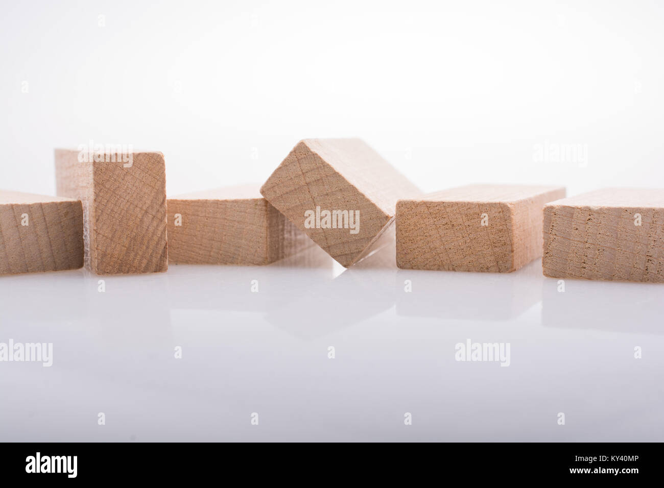 Wooden Domino Blocks in a line on a white background Stock Photo - Alamy