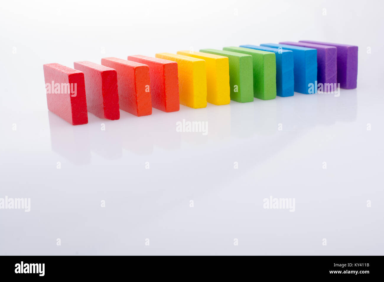 Colorful Domino Blocks in a line on a white background Stock Photo - Alamy
