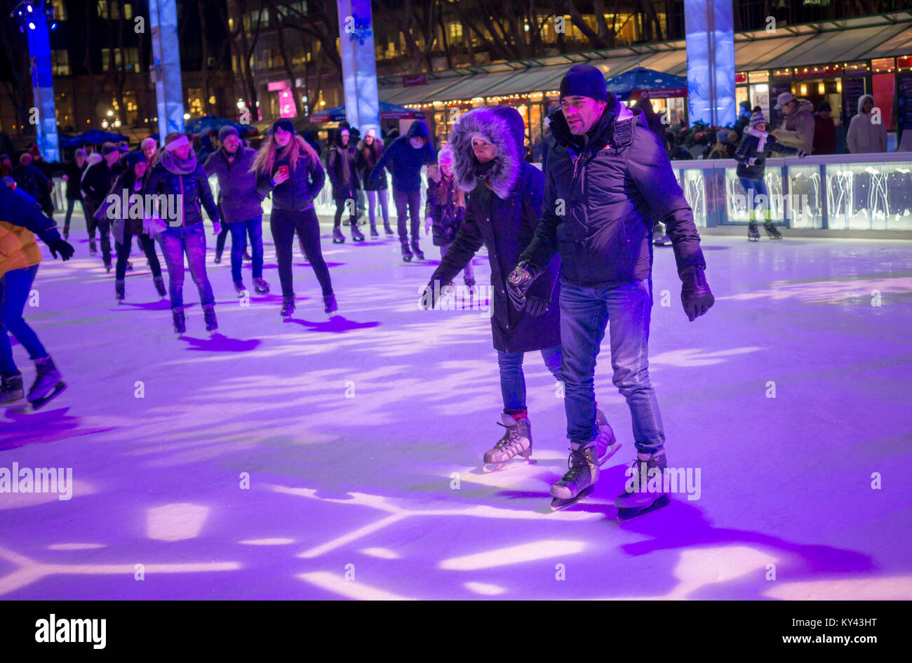 Skaters maneuver the packed Winter Village ice skating rink at Bryant ...