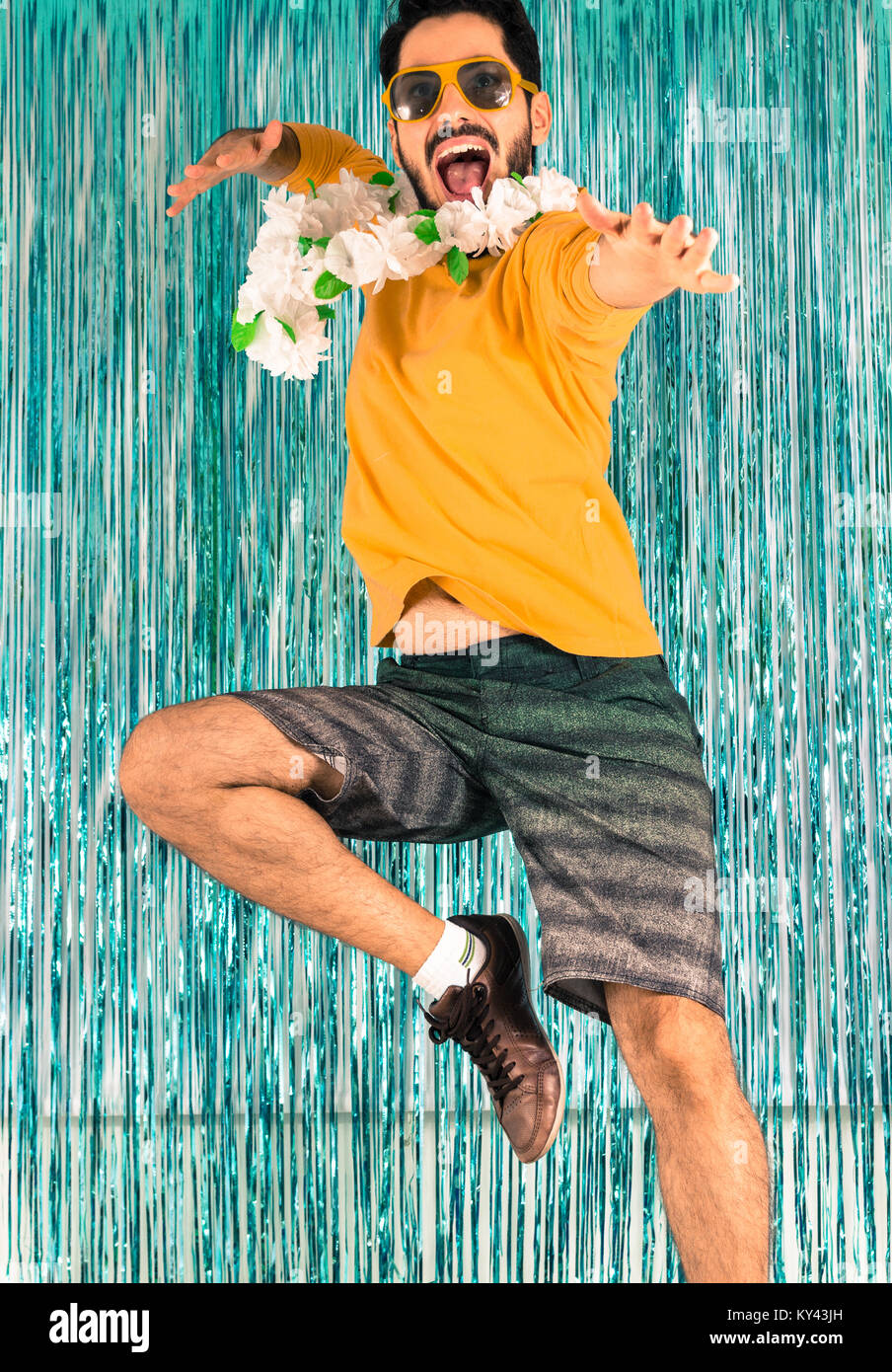 Brazilian jumps for joy, crazy pose in the air. Bearded man in green ...