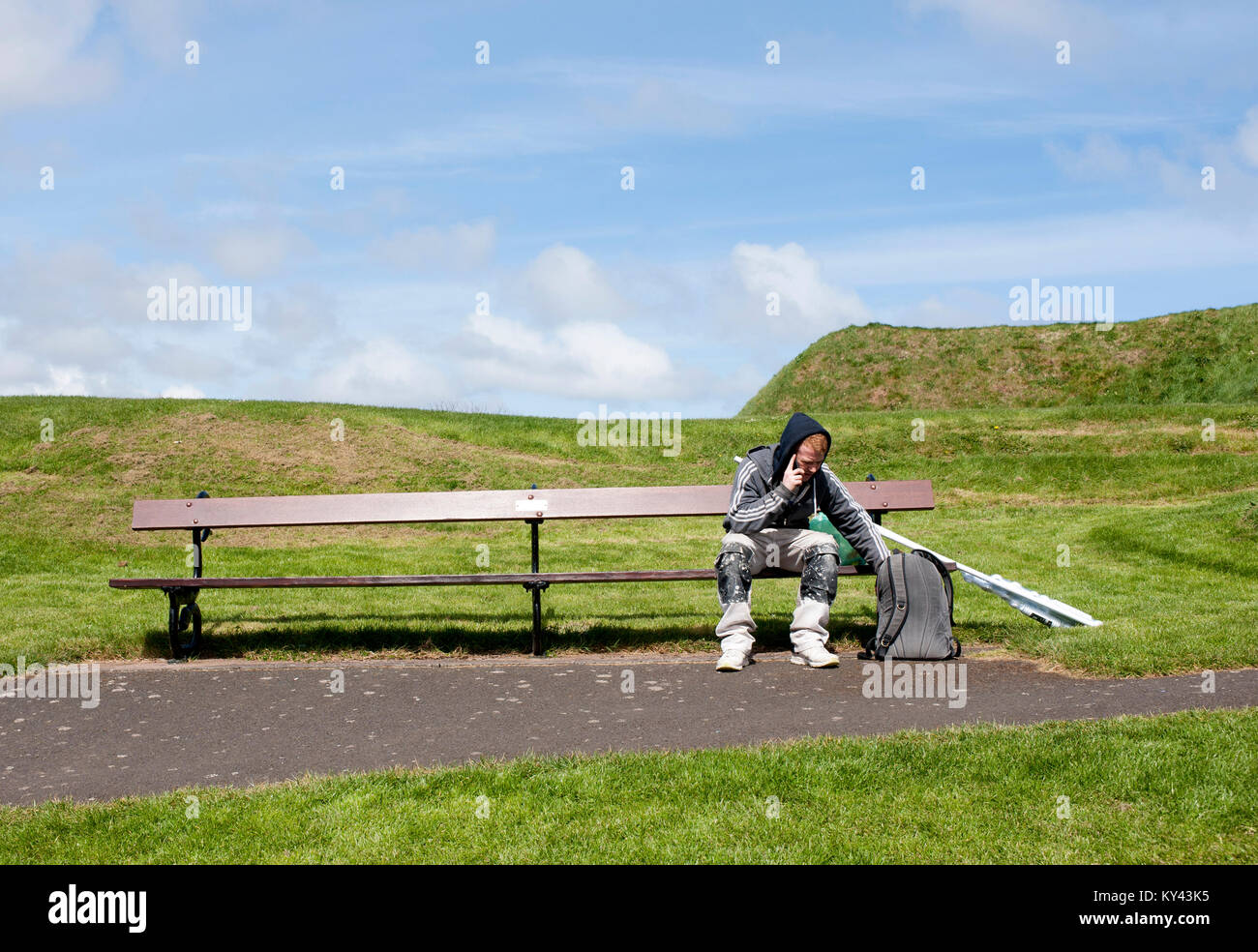 Workman making a phone call whilst sitting on a bench in Berwick-Upon ...