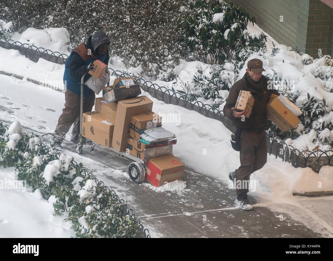 A UPS worker and a seasonal helper with their post-Christmas deliveries ...