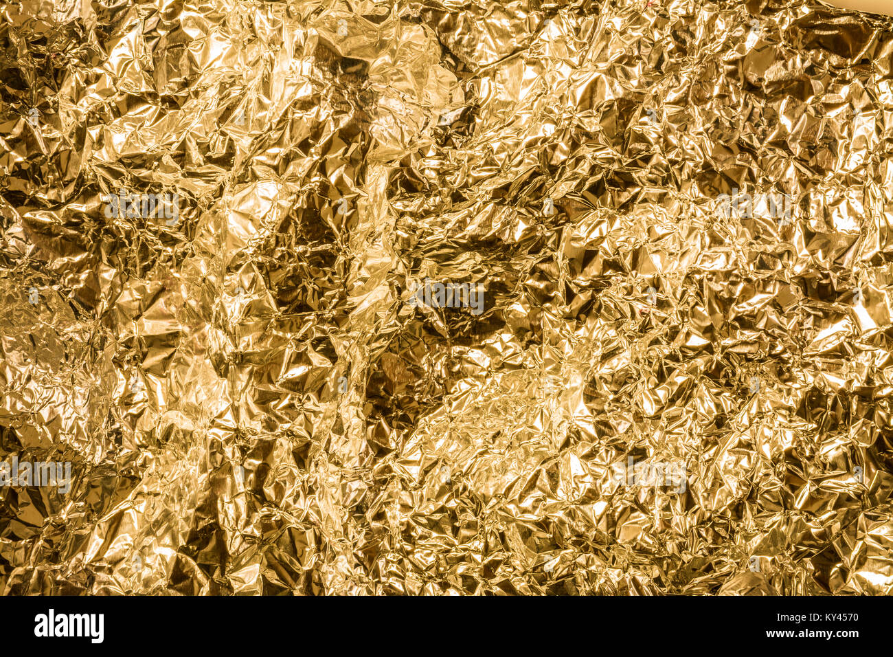 Shiny gold abstract background. Vivid gleamy texture from crumpled ...