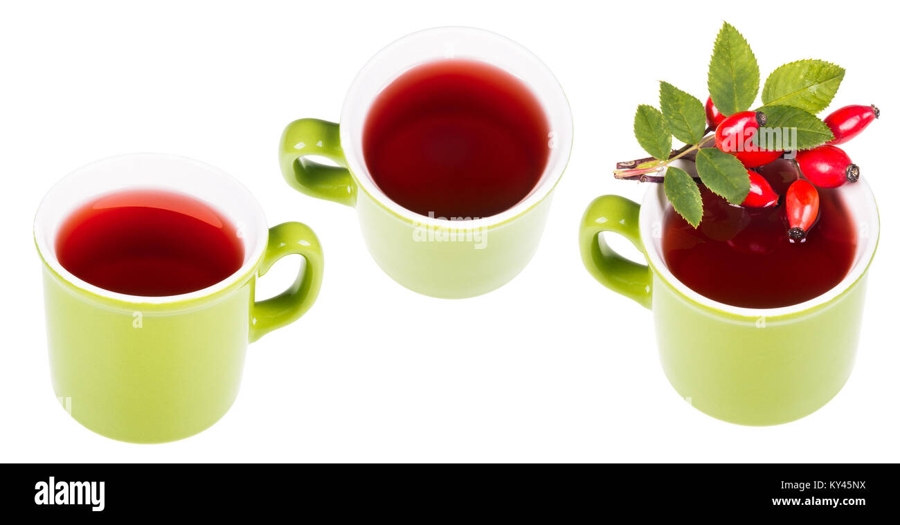 Three green mugs with hot medicinal tea from rose hips. Red rosehip ...