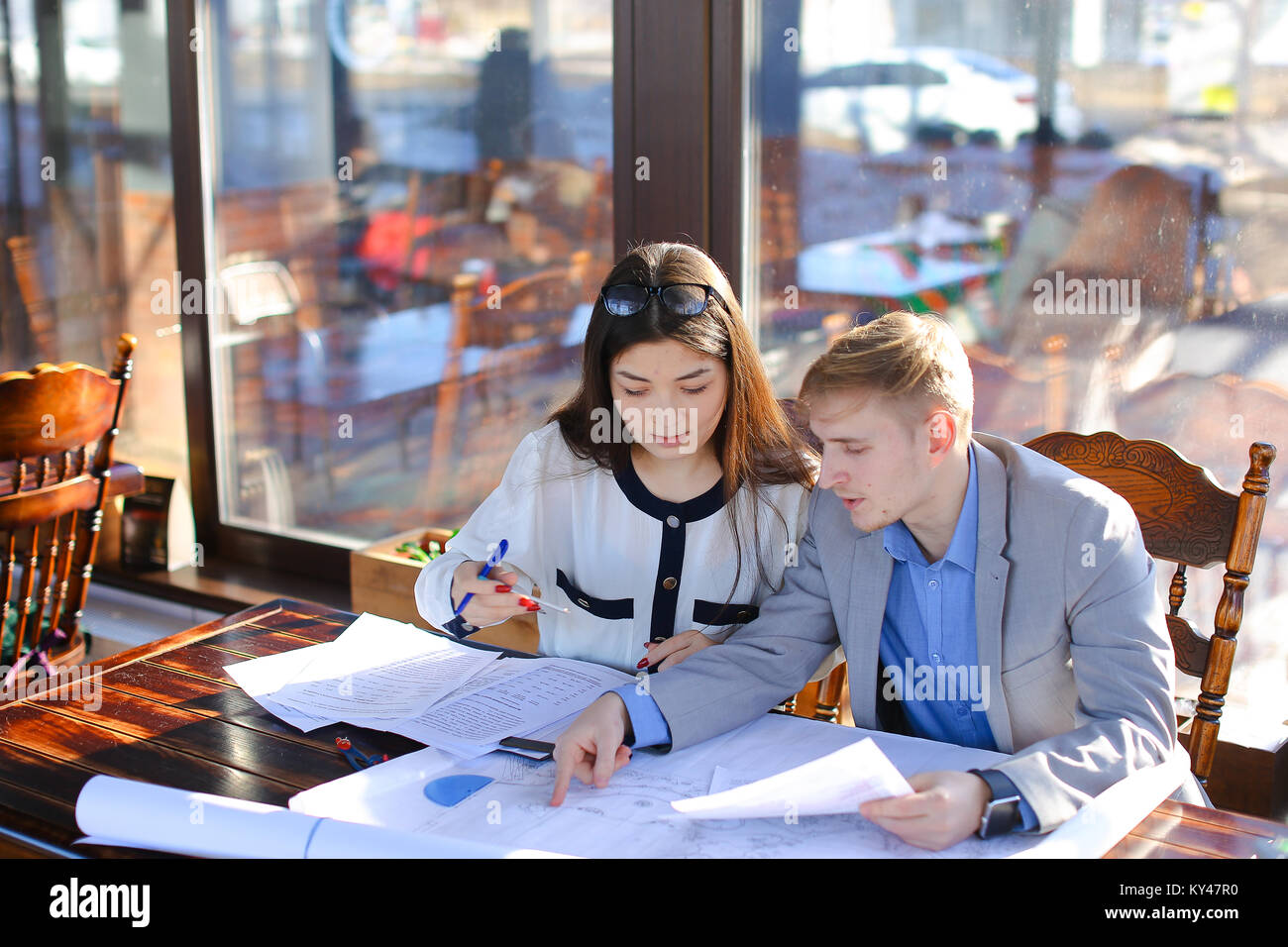 Students calling professor by smartphone and working with archit Stock ...
