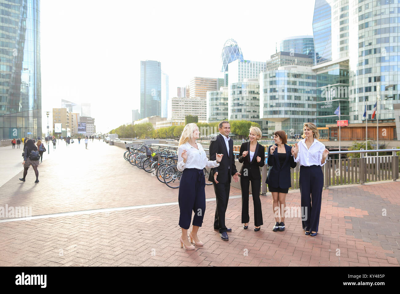 Businesswomen speaking with male boss outside Stock Photo - Alamy