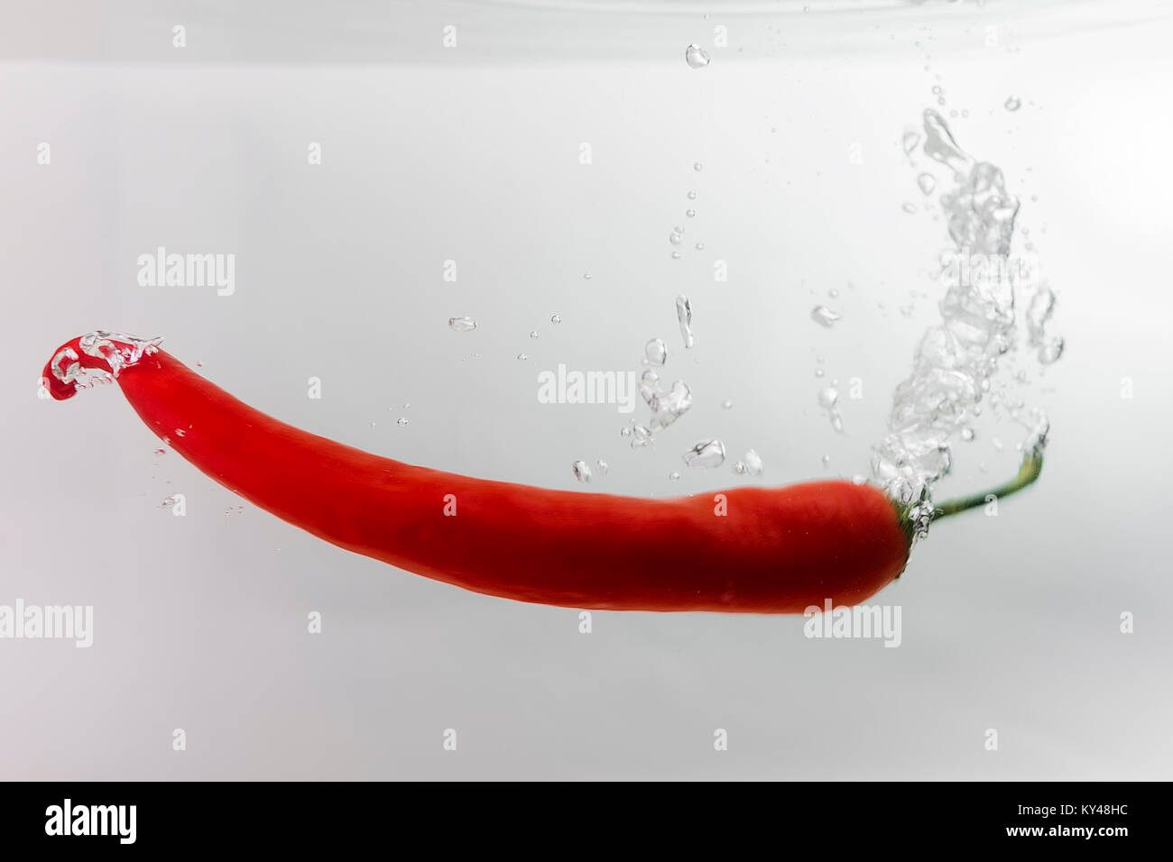 Red pepper splash water Stock Photo - Alamy