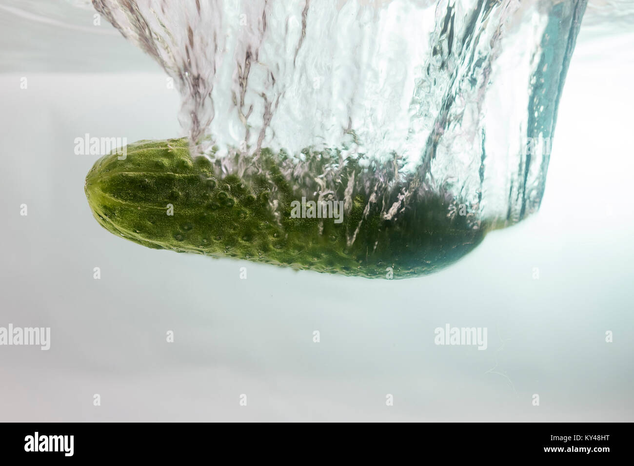 A green cucumber splash of water Stock Photo - Alamy