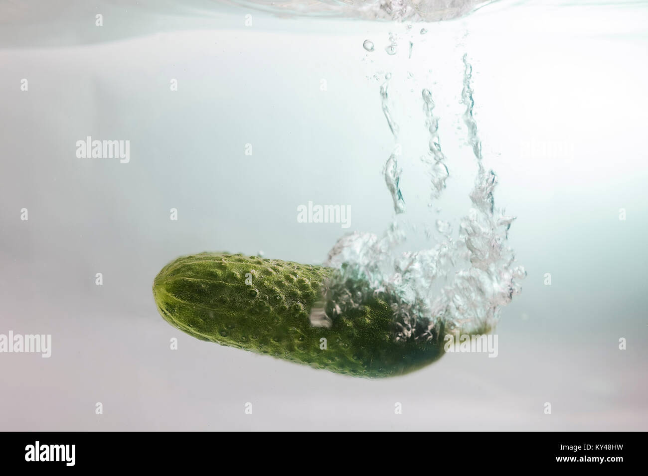 A green cucumber splash of water Stock Photo - Alamy