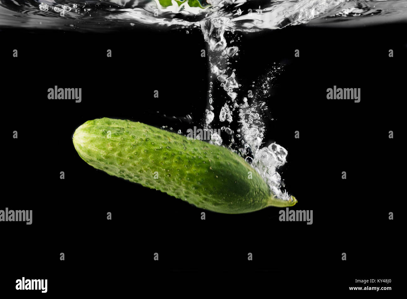 A green cucumber splash of water Stock Photo - Alamy