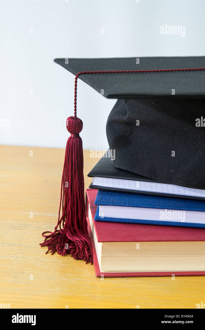 Closeup on black bonnet for graduation ceremony on top of books Stock ...