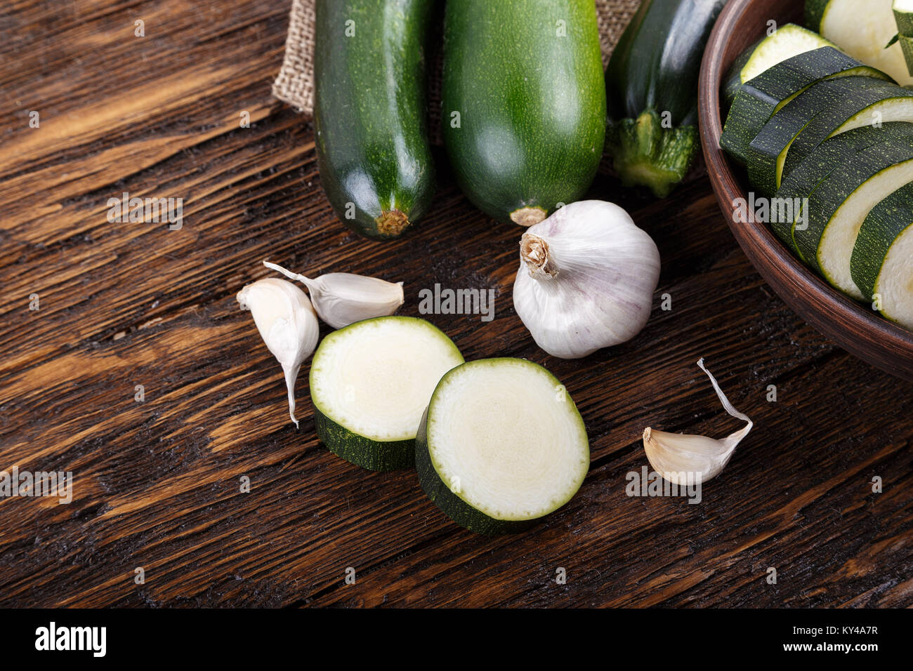 Raw zucchini slices and whole, cooking vegetarian food, space for text ...