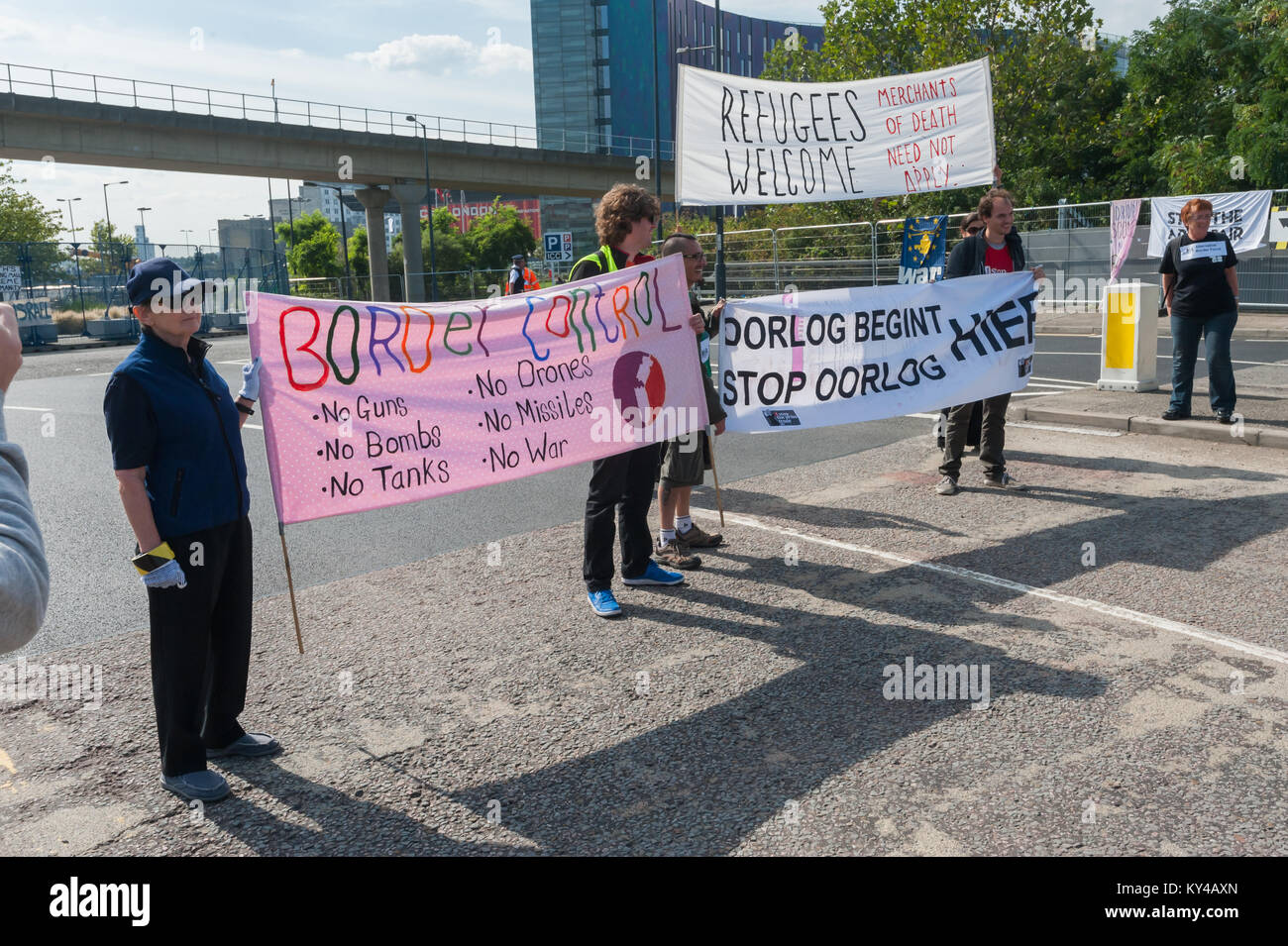 People stand with 'Border Control' banner on the raod in front of a ...