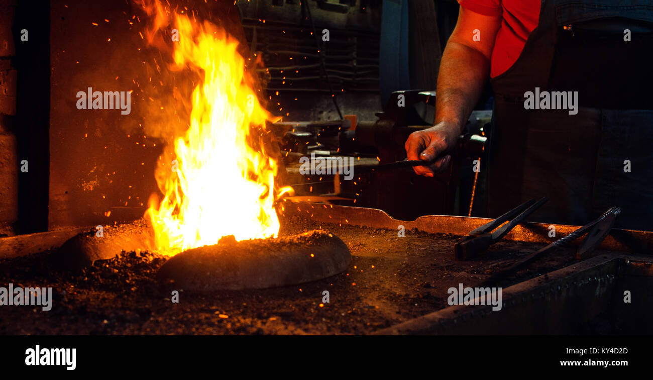 Blacksmith at work, hit with a hammer by a hot metal on the anvil Stock ...