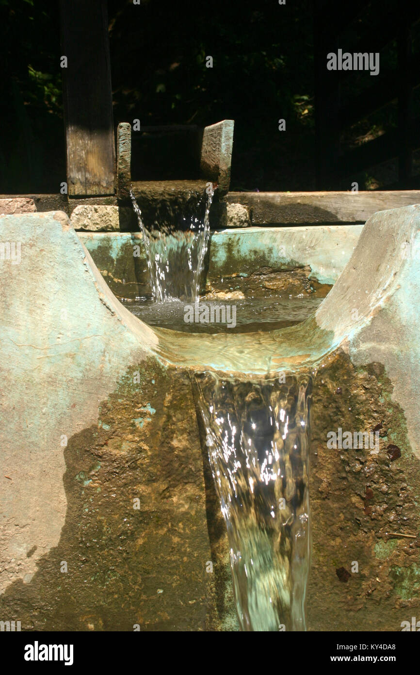 Spring water pouring down Stock Photo - Alamy
