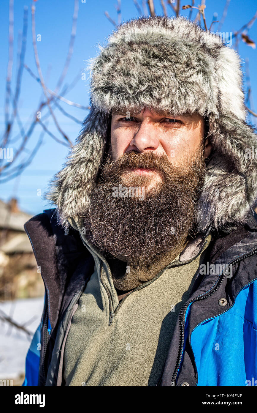 Closeup portrait of a bearded young man with fur cap outdoor Stock ...