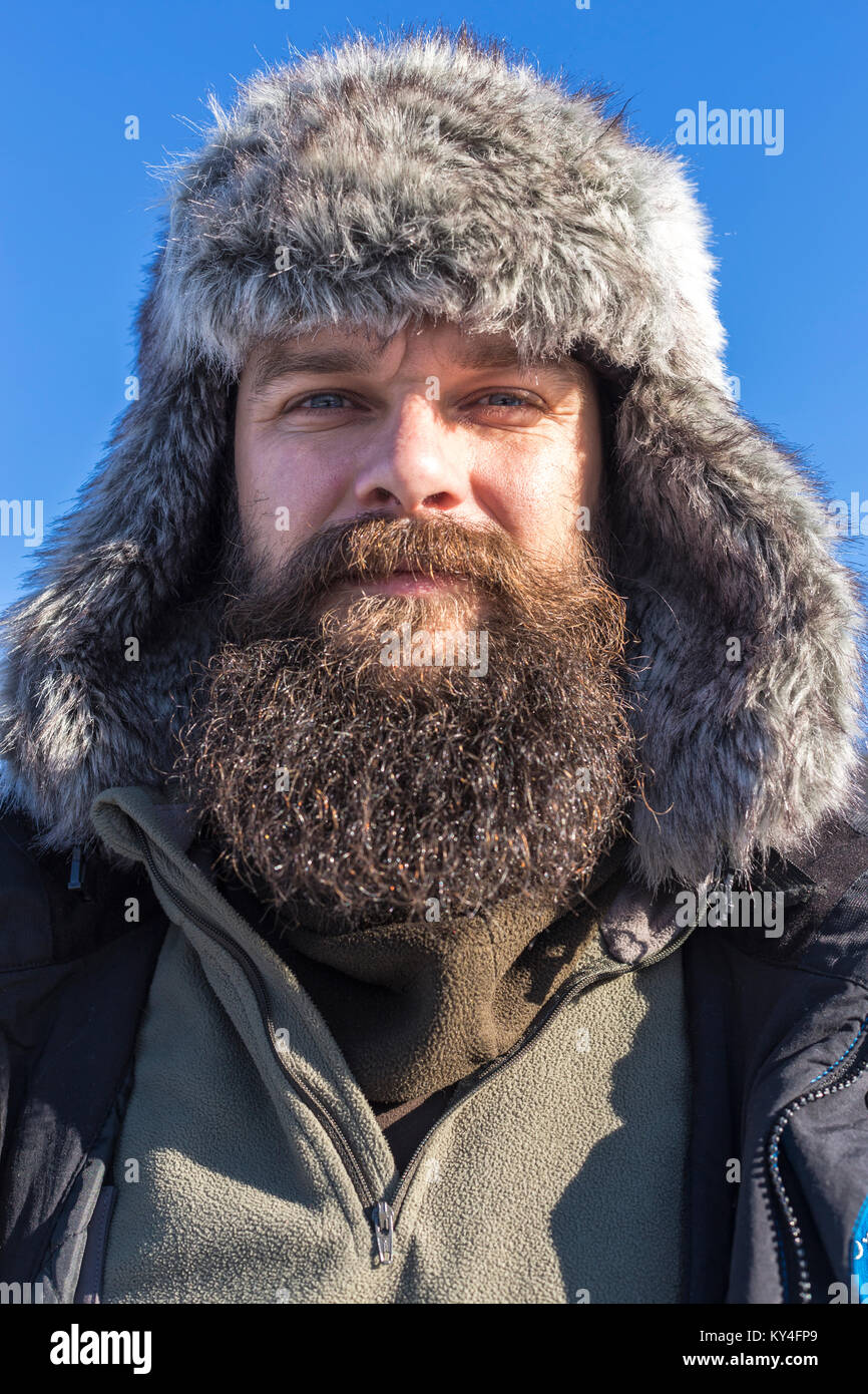 Closeup portrait of a bearded young man with fur cap outdoor Stock ...