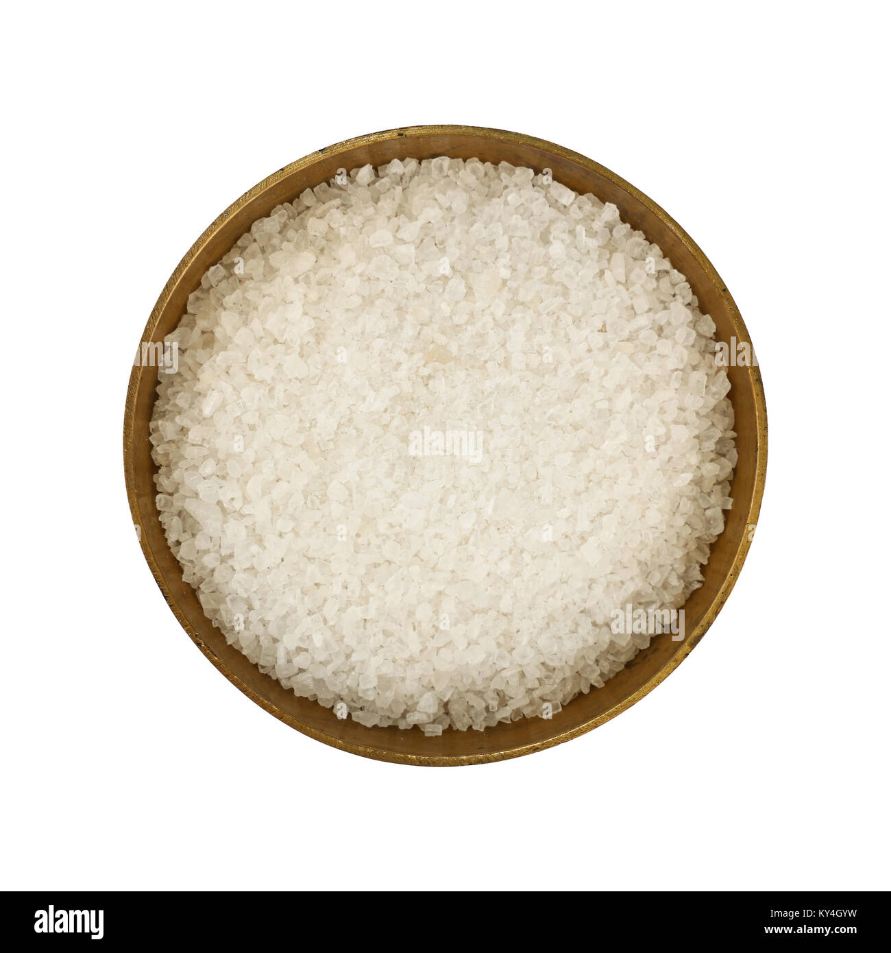 Close up one vintage bronze metal bowl full of white marine rock salt ...