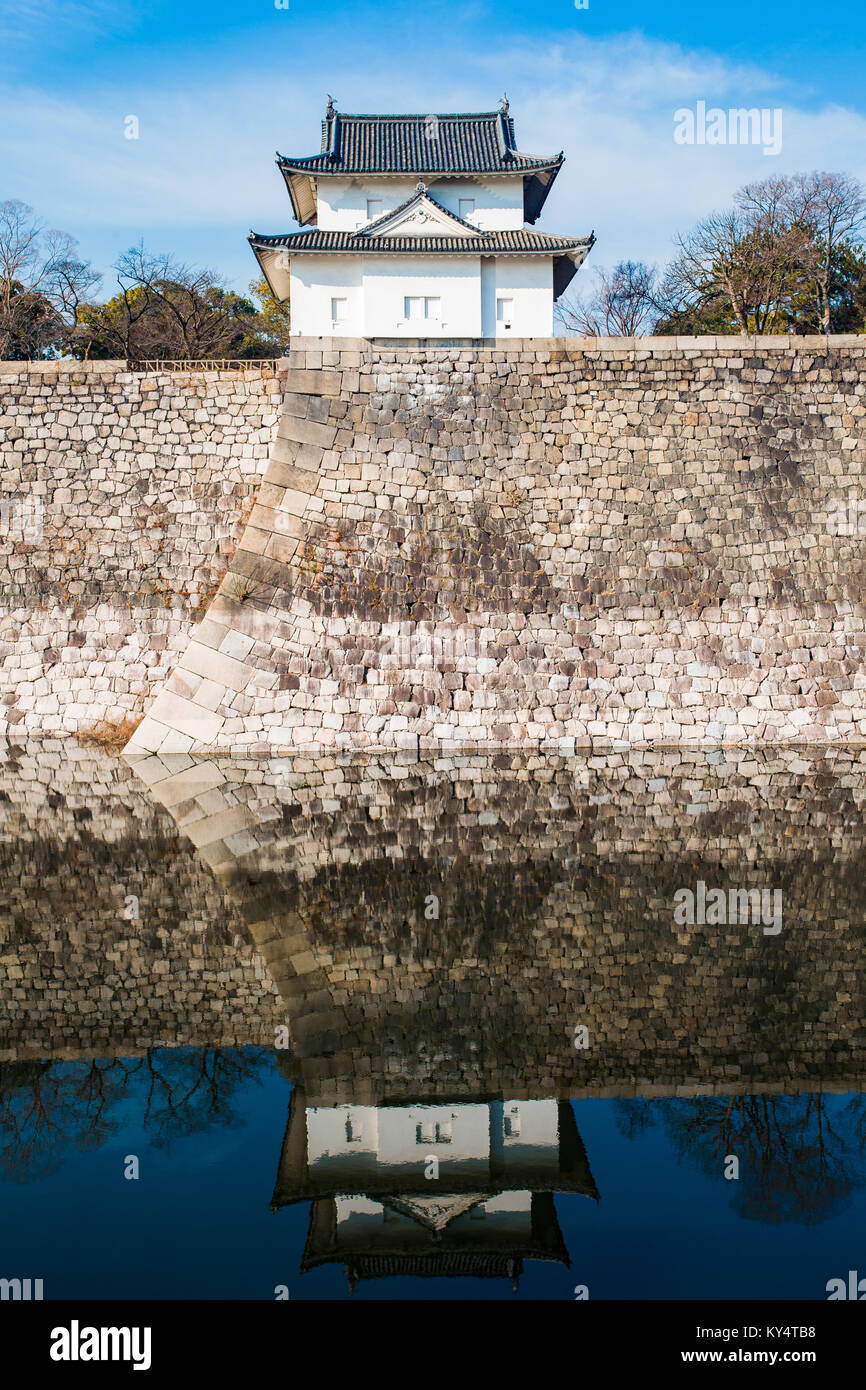 The Osaka Castle guard house at the edge of the complex wall, reflected ...