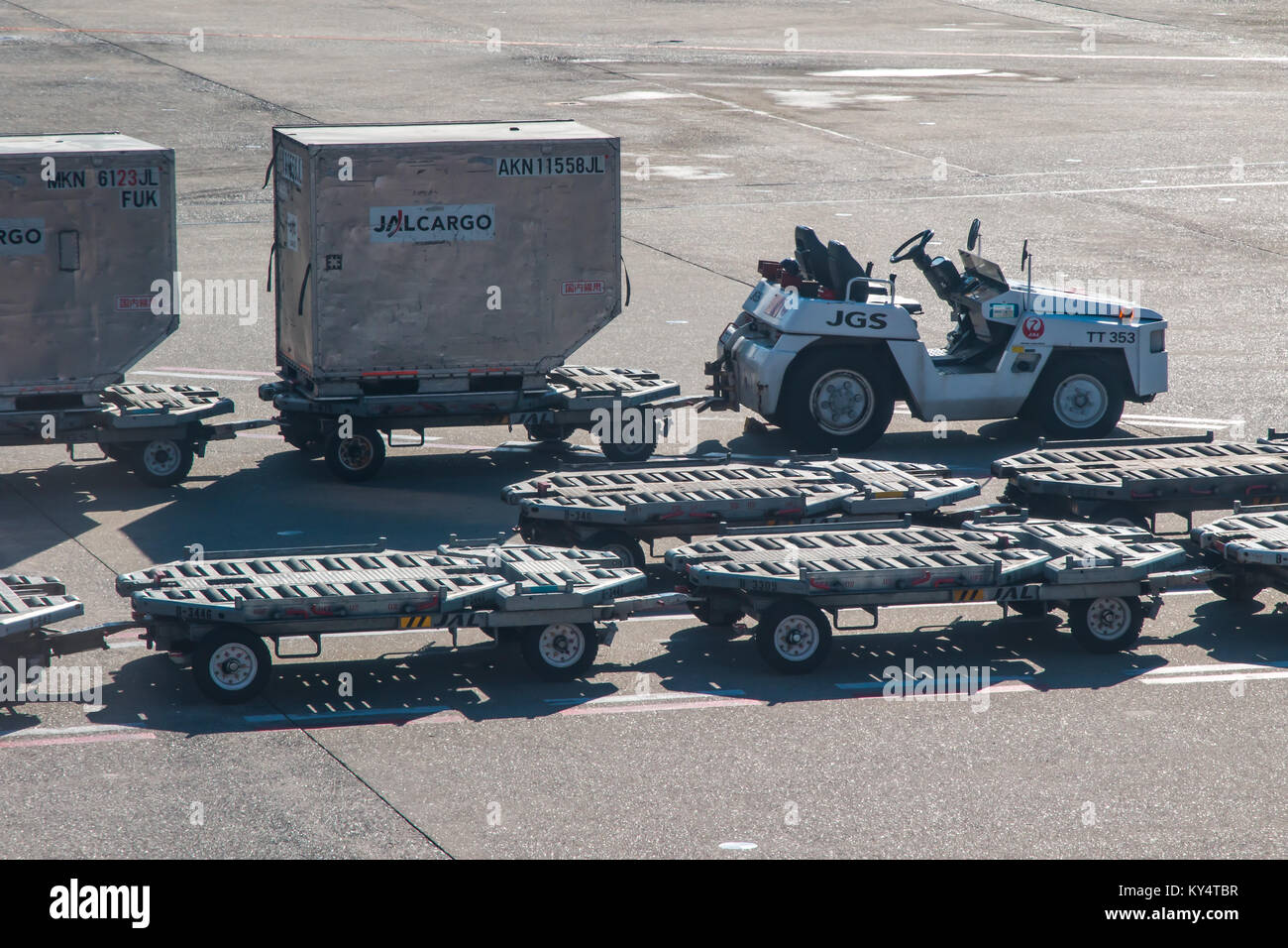 Japan Airlines cargo trolley on standby loaded with containers Stock ...