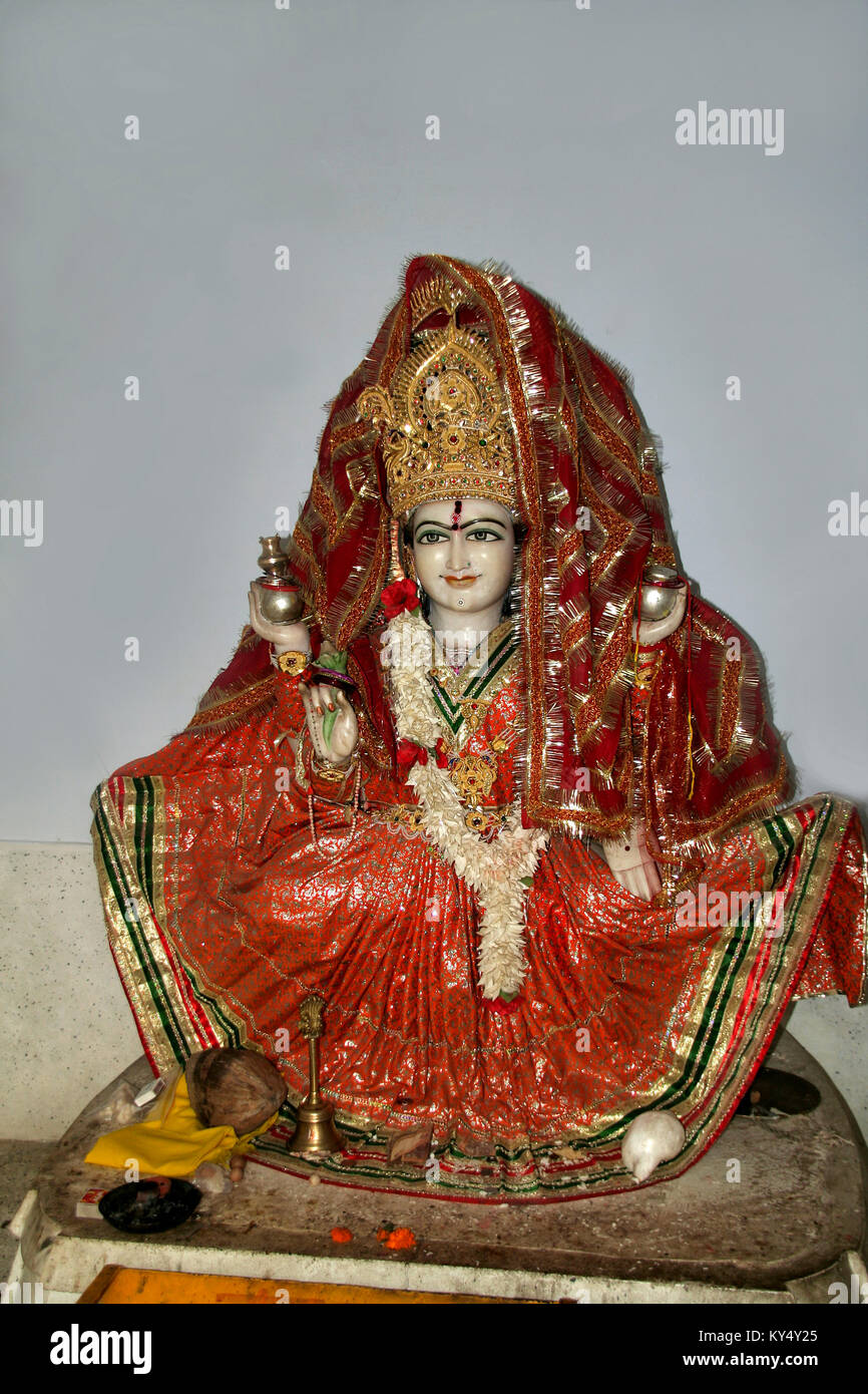 Marble icon of smiling, bedecked goddess in Rishikesh, Uttarakhand ...