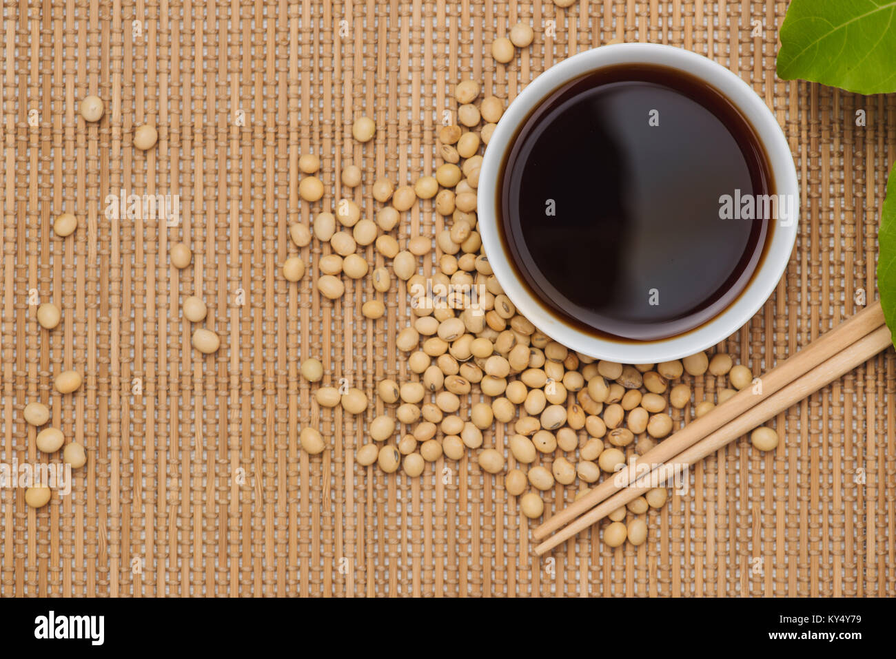 Soy sauce and soy bean with chopsticks on wooden table Stock Photo - Alamy