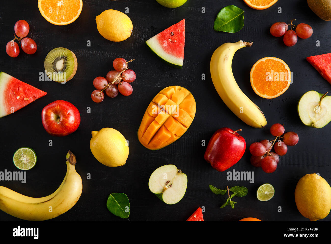 top view portrait of fresh mixed tropical fruits pattern on black ...