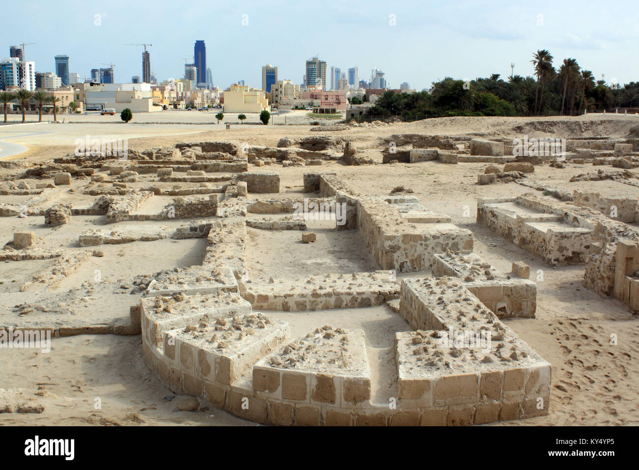 Ruins of fort Bahrein and high buildings of Manama city Stock Photo - Alamy