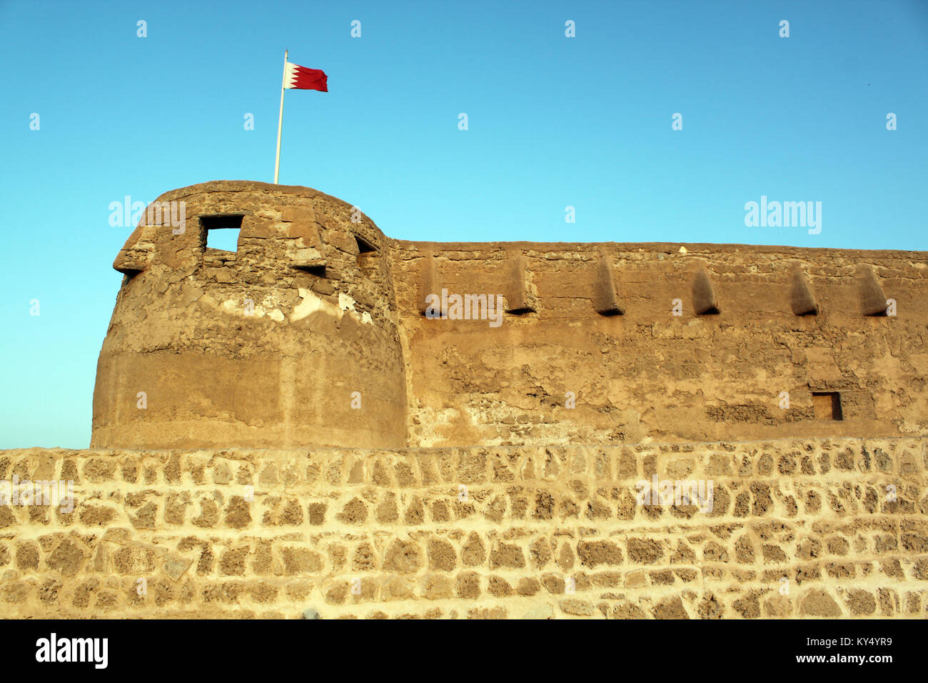 Flag, tower, wall of fort Arad in Manama city, Bahrein Stock Photo - Alamy