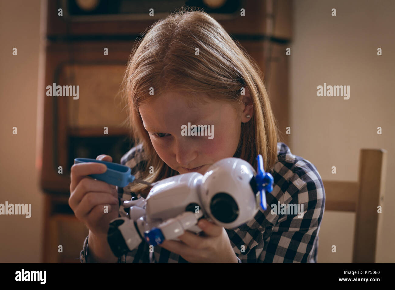 Girl fixing the robotic toy Stock Photo - Alamy