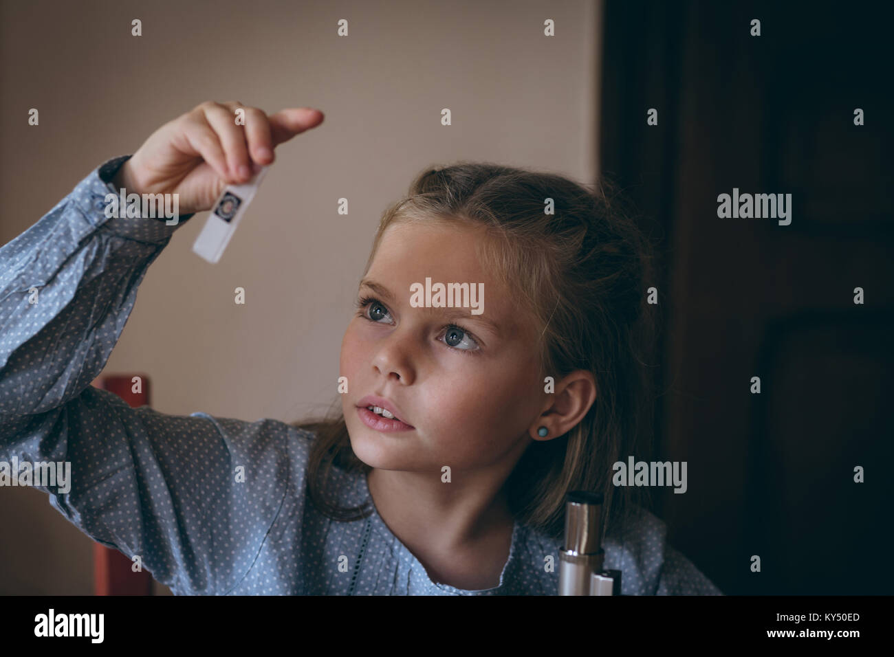 Girl examining the glass slide Stock Photo - Alamy