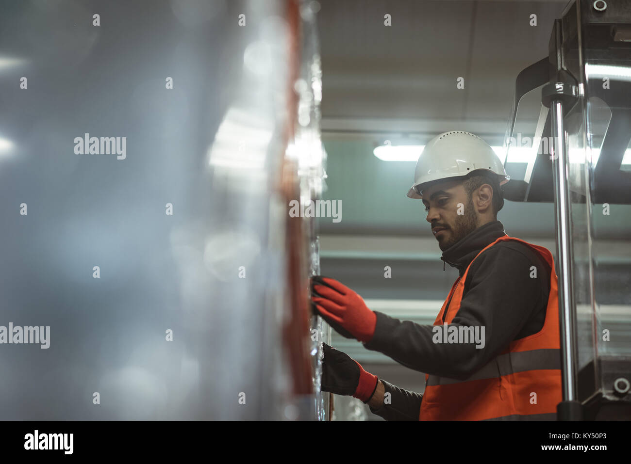 Male worker checking machine Stock Photo - Alamy