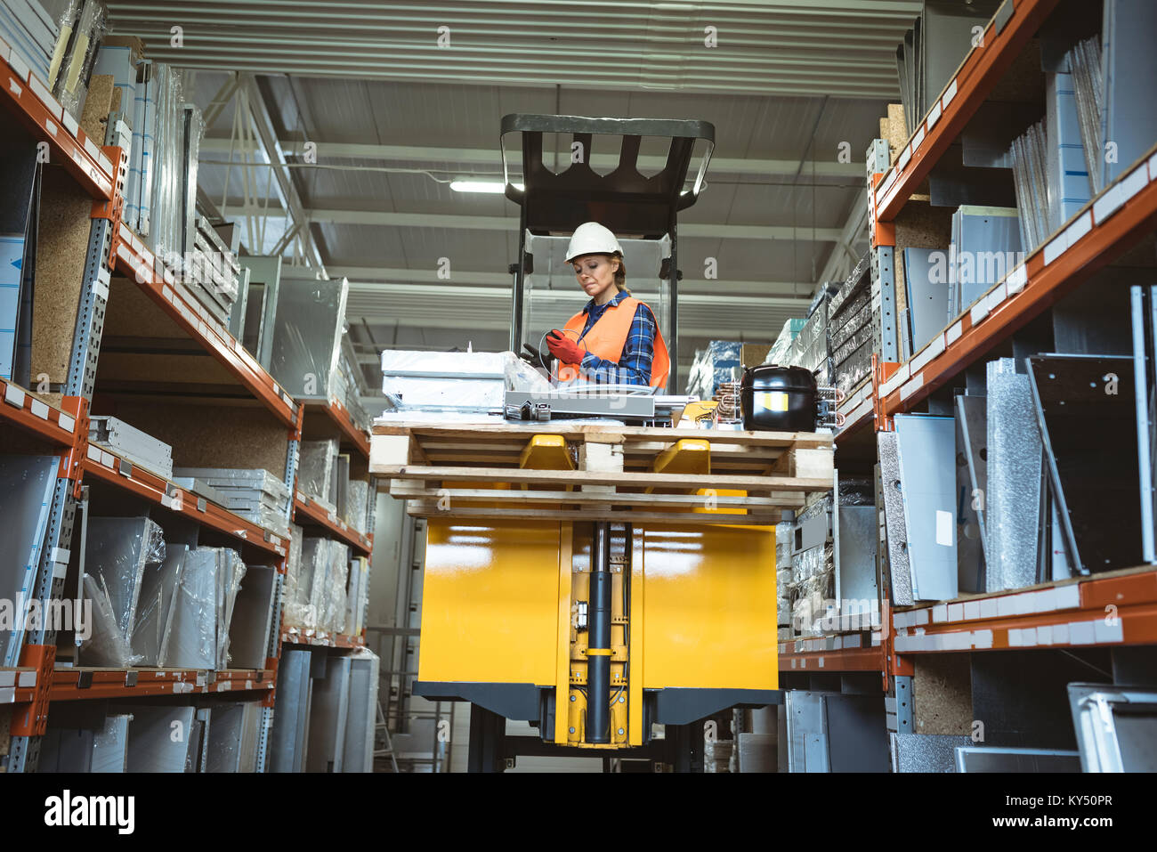 Female worker checking machine part Stock Photo - Alamy