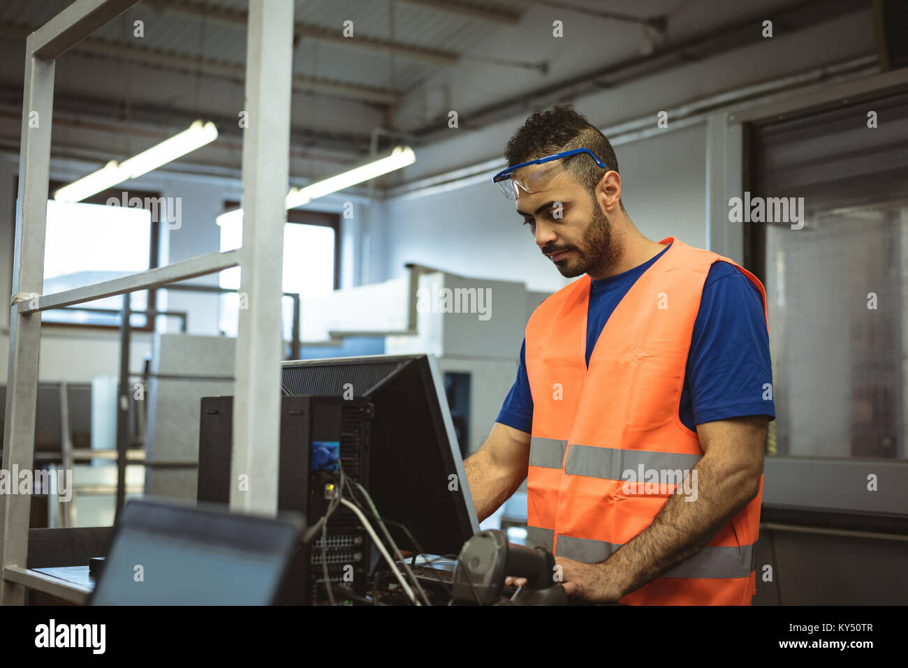 Male worker working on computer Stock Photo - Alamy