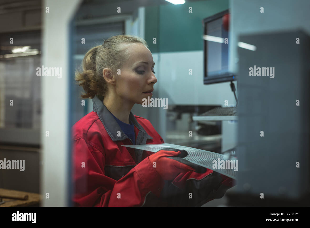 Female worker checking a machine board Stock Photo - Alamy