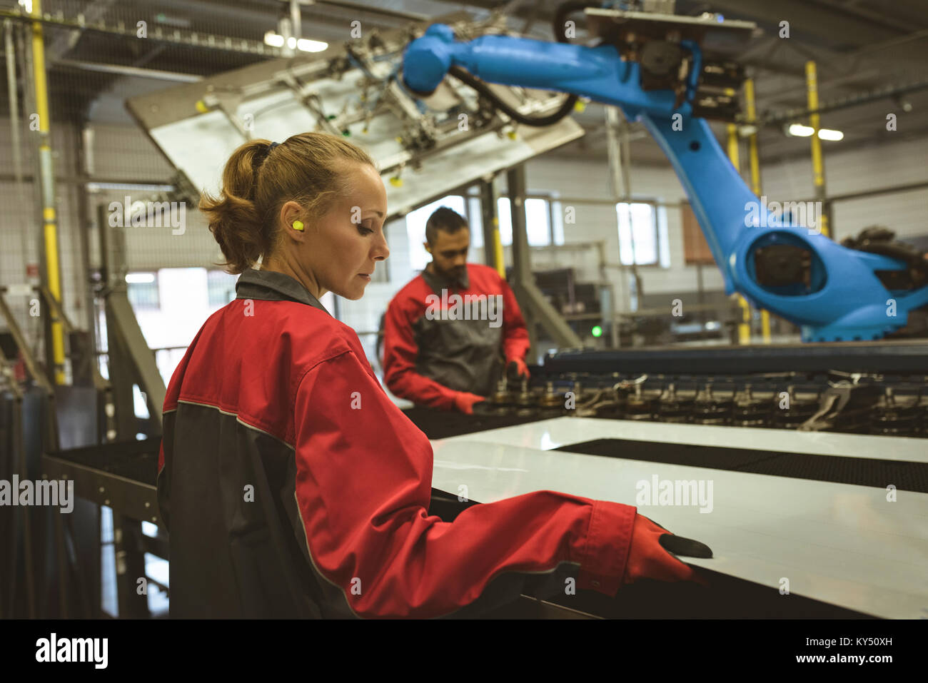 Female worker checking a glass sheet Stock Photo - Alamy
