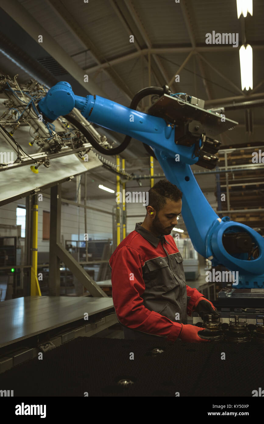 Male worker checking a machine part Stock Photo - Alamy