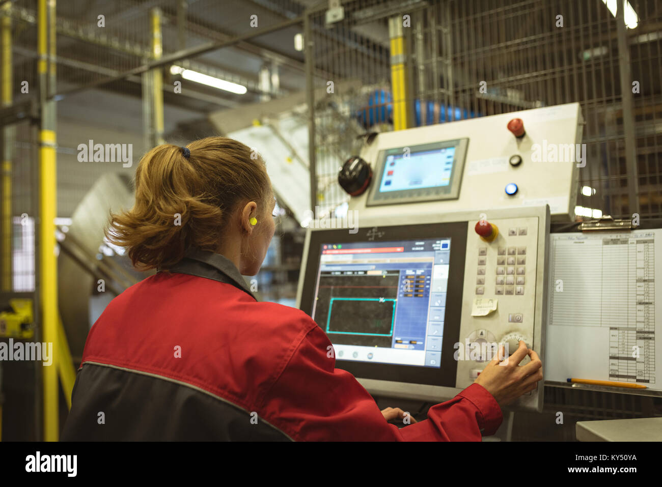 Female worker operating machine Stock Photo - Alamy