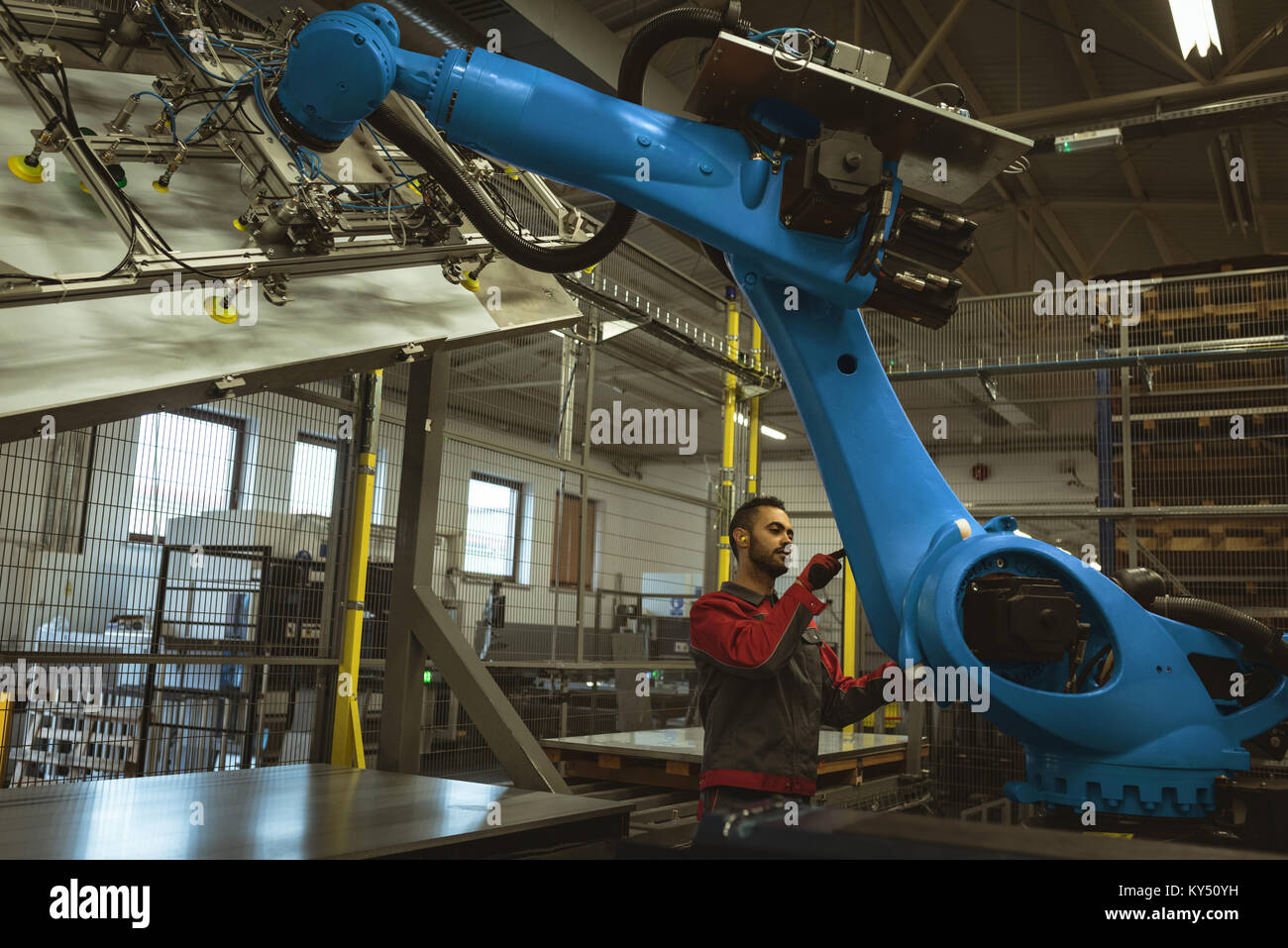 Male worker checking robotic machine Stock Photo - Alamy